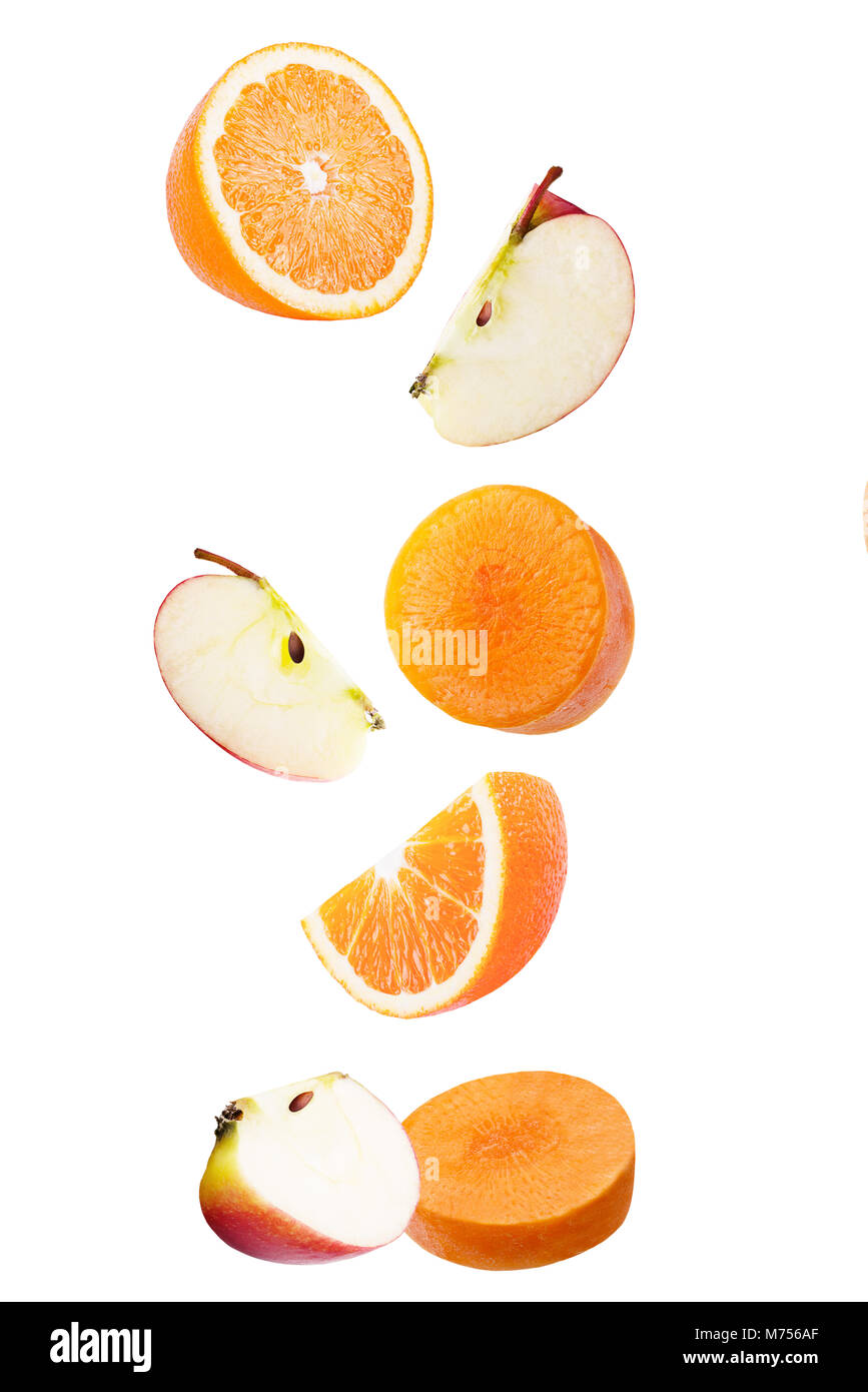 Isolated falling fruits. Falling apple, orange and carrot isolated on ...