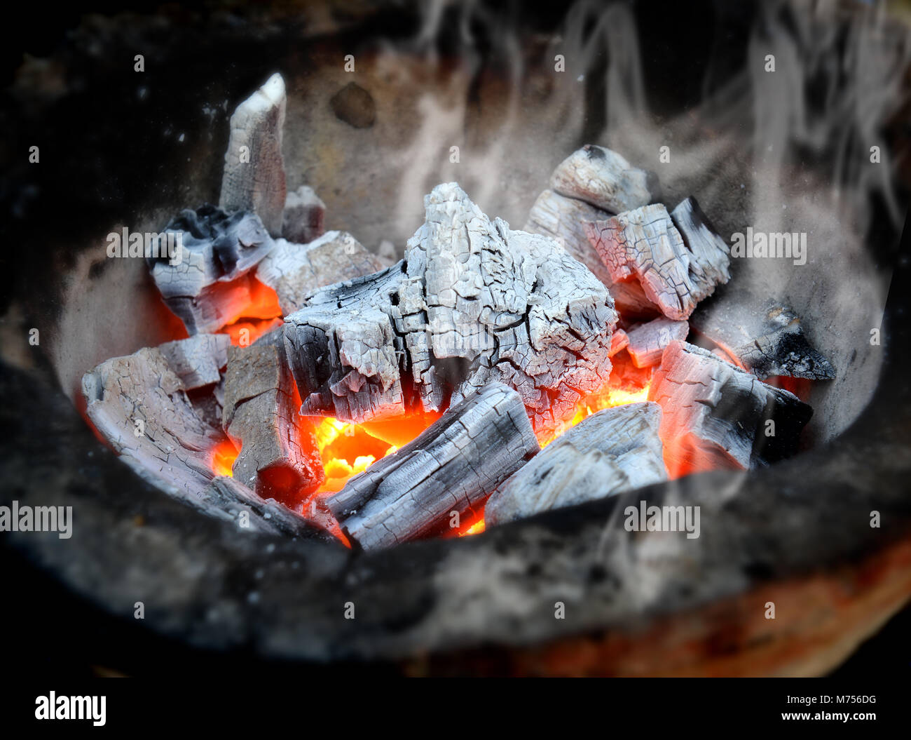 Hot fire of charcoal burning in the stove photo in outdoor after sunset ...