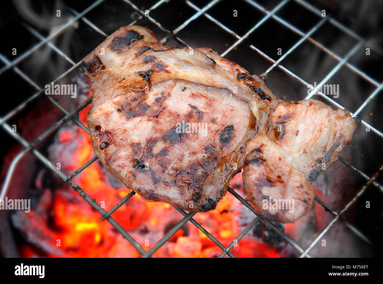 Pork meat on Hot fire of charcoal burning in the stove photo in outdoor ...