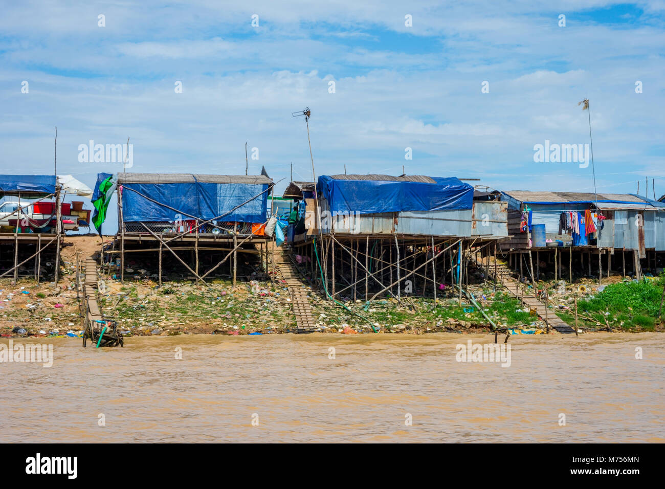 SIEM REAP, CAMBODIA - APRIL 8: Water canals with houses on the pillars ...