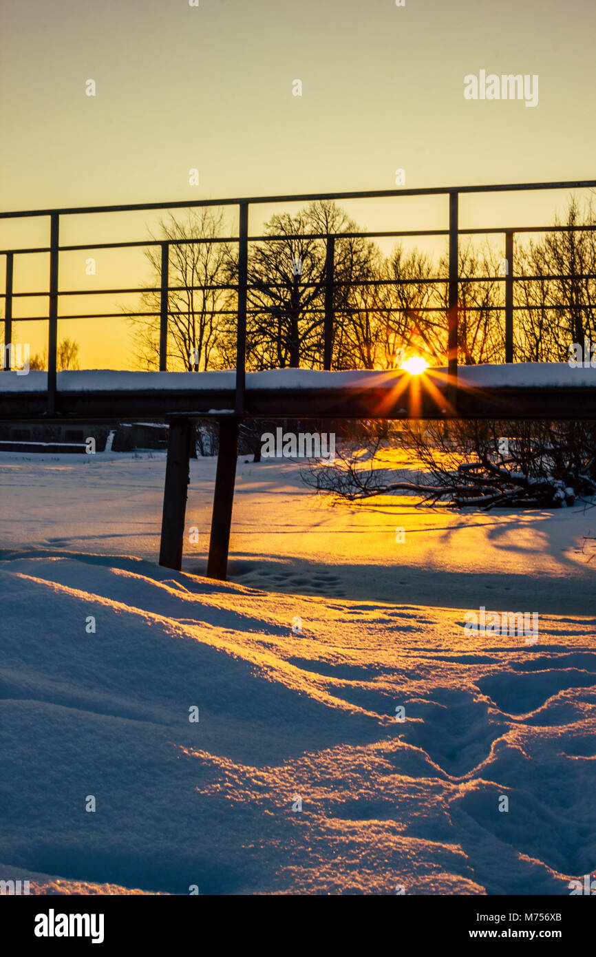 Snowy Bridge in a Countryside with the Sun Rays Gloving over it ...
