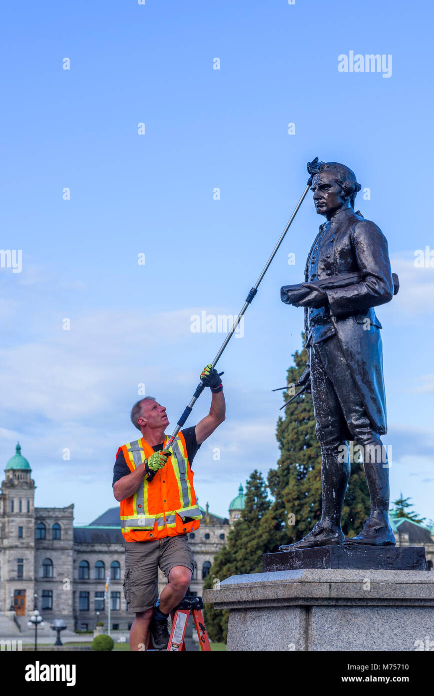 City worker cleaning bird poop from statue of Captain Cook, Victoria ...