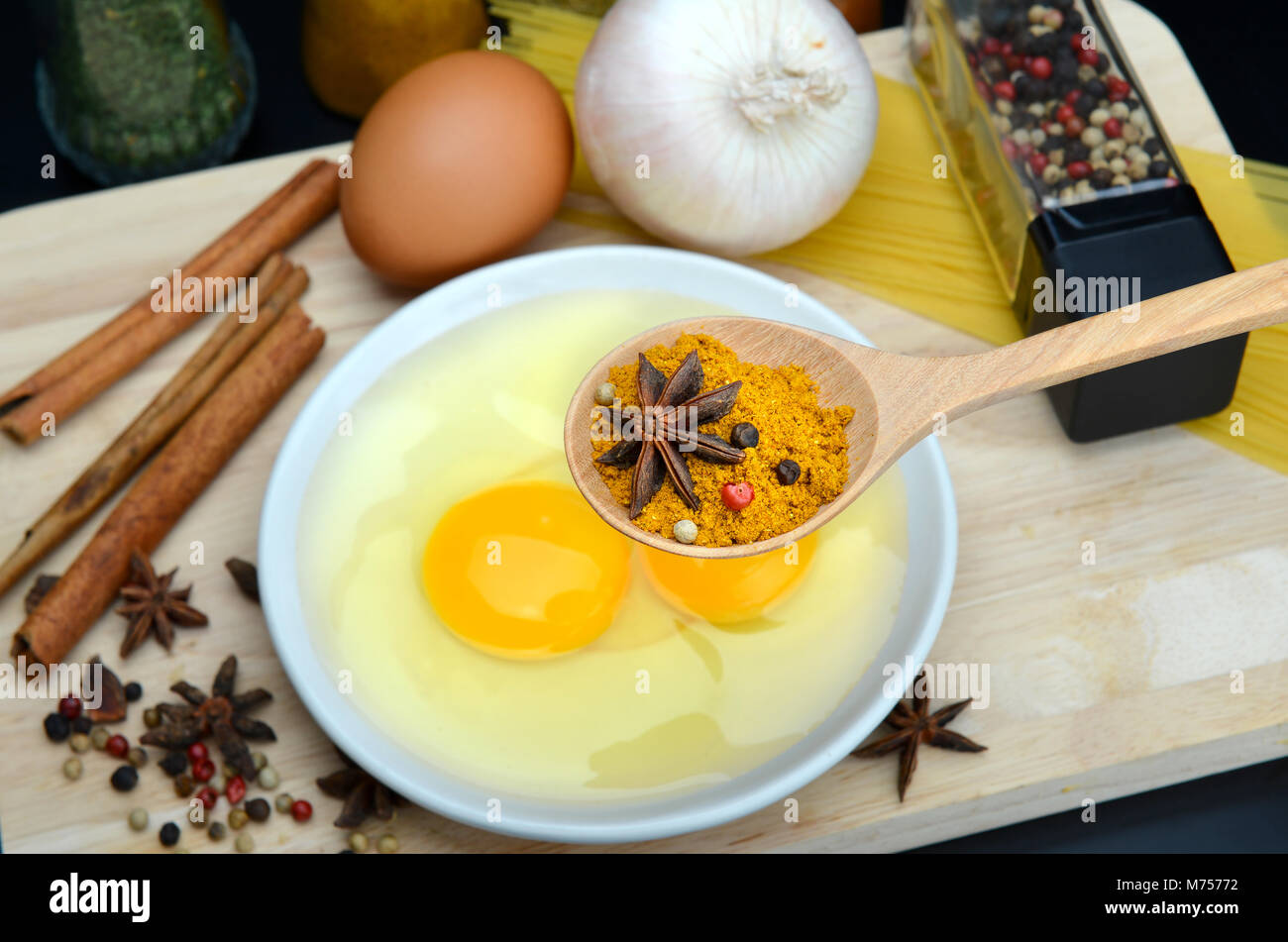 raw egg with spices set in the kitchen objects Stock Photo - Alamy
