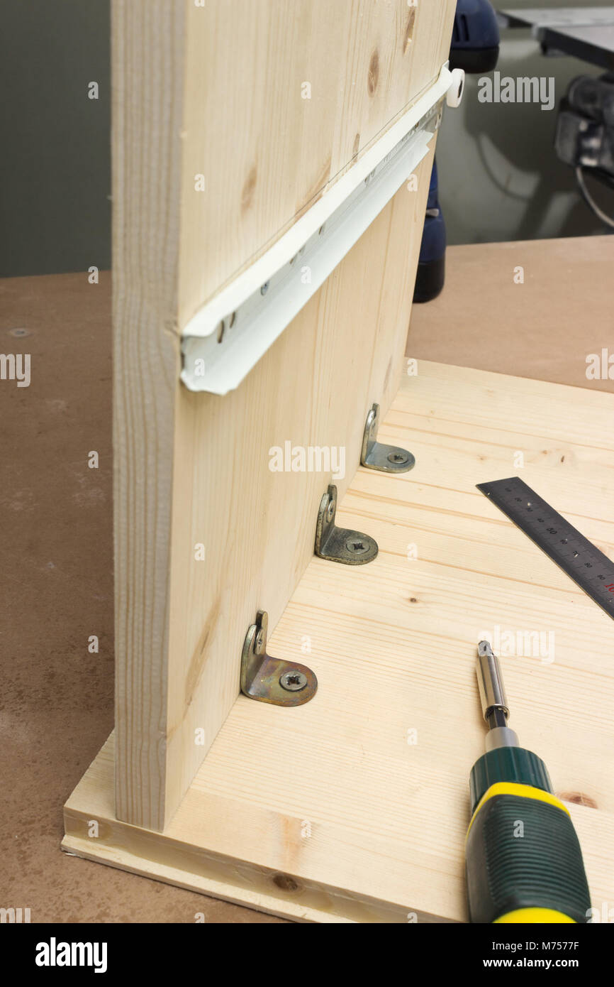 Connection of two wooden panels and furniture metal parts Stock Photo ...