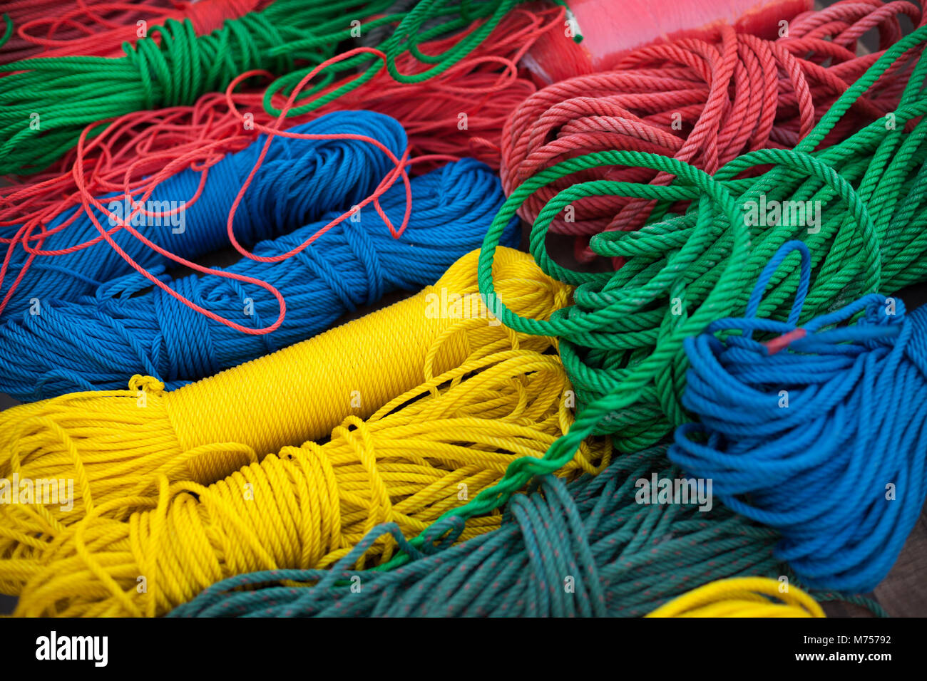 Variety of colored twisted rope, collected into bundles Stock Photo - Alamy