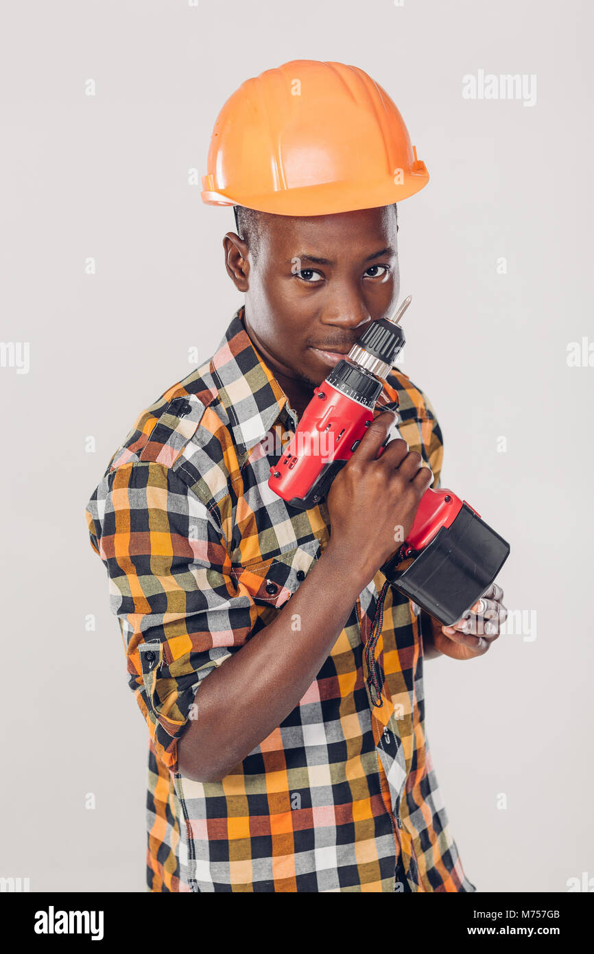 African American worker uses electric screwdriver Stock Photo - Alamy