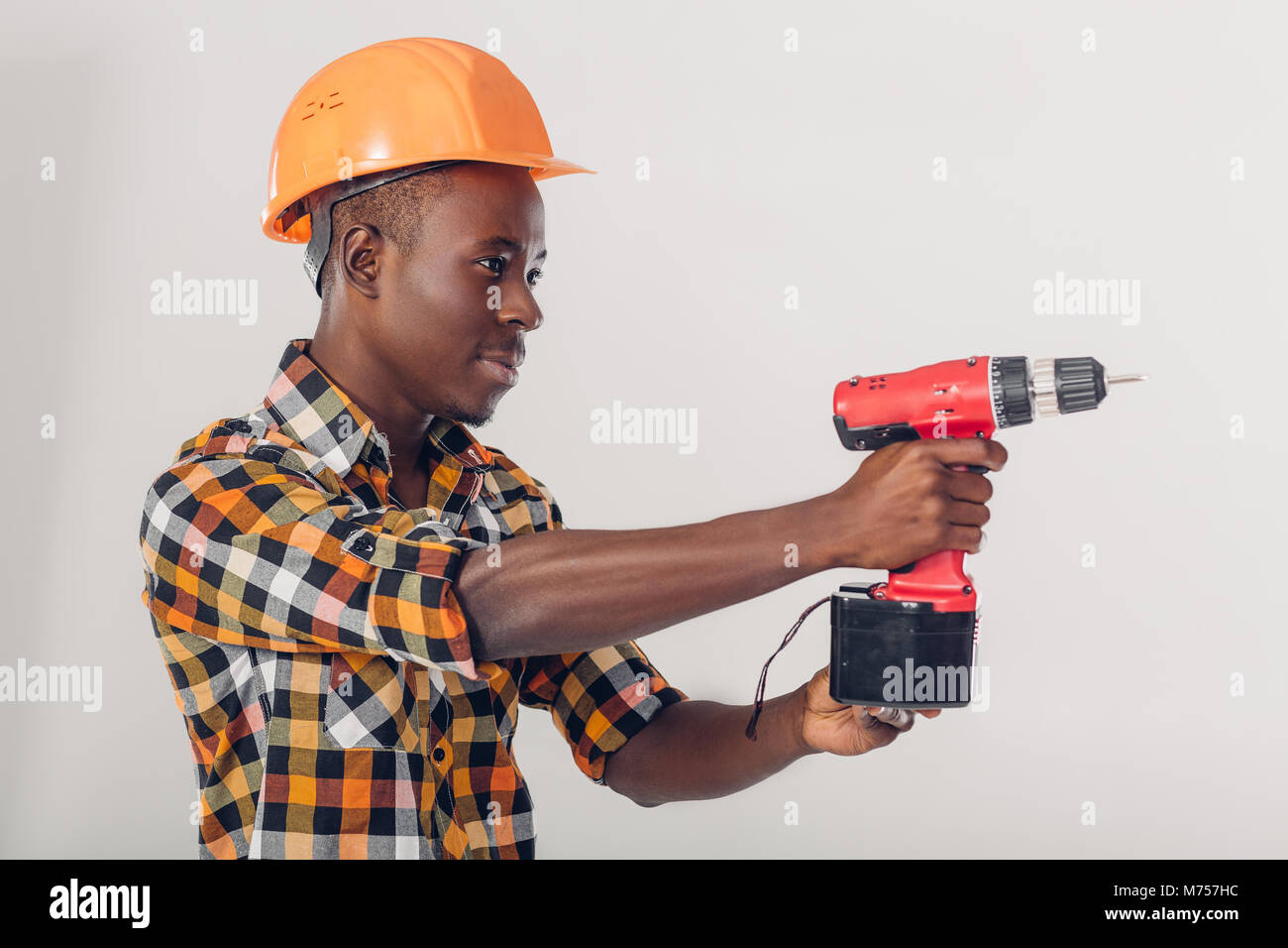 African American worker uses electric screwdriver Stock Photo - Alamy
