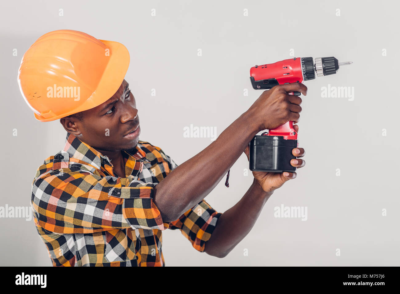 African American worker uses electric screwdriver Stock Photo - Alamy