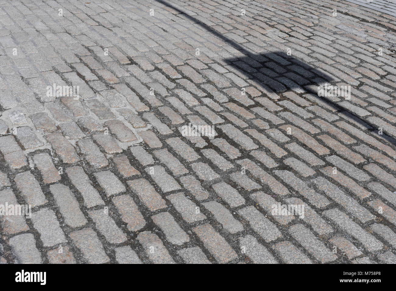 Old cobblestone street / area in sunshine Stock Photo - Alamy