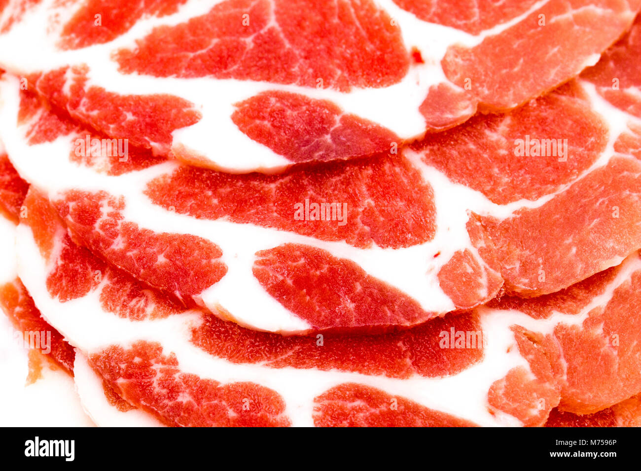 Close-up sliced raw pork isolated on white background. It copy space ...