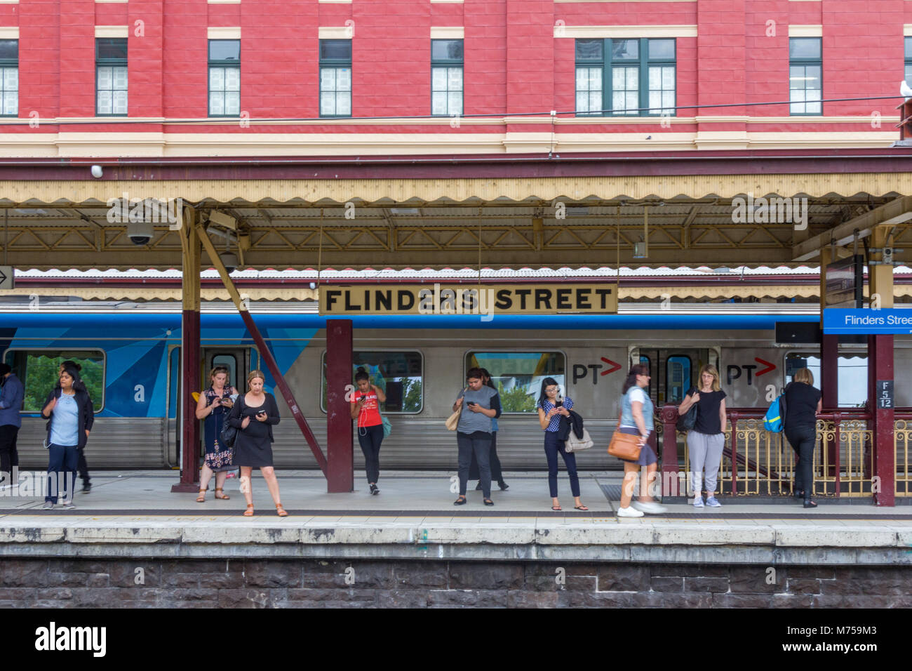 Passengers waiting for train, platform, Flinders Street station ...