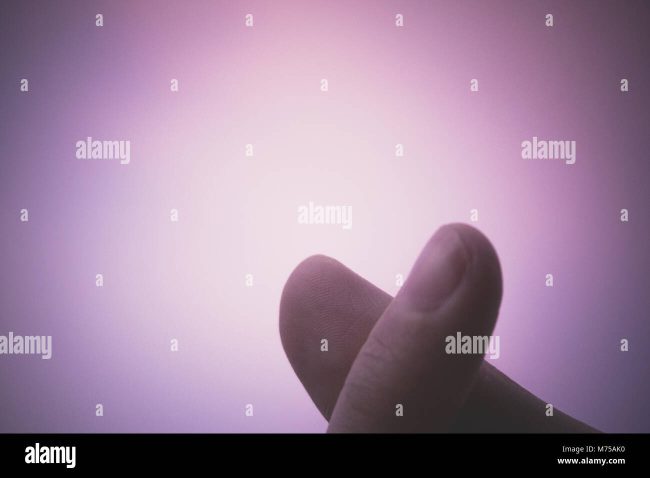 silhouette of crossed fingers in heart form as the symbol of mini heart ...