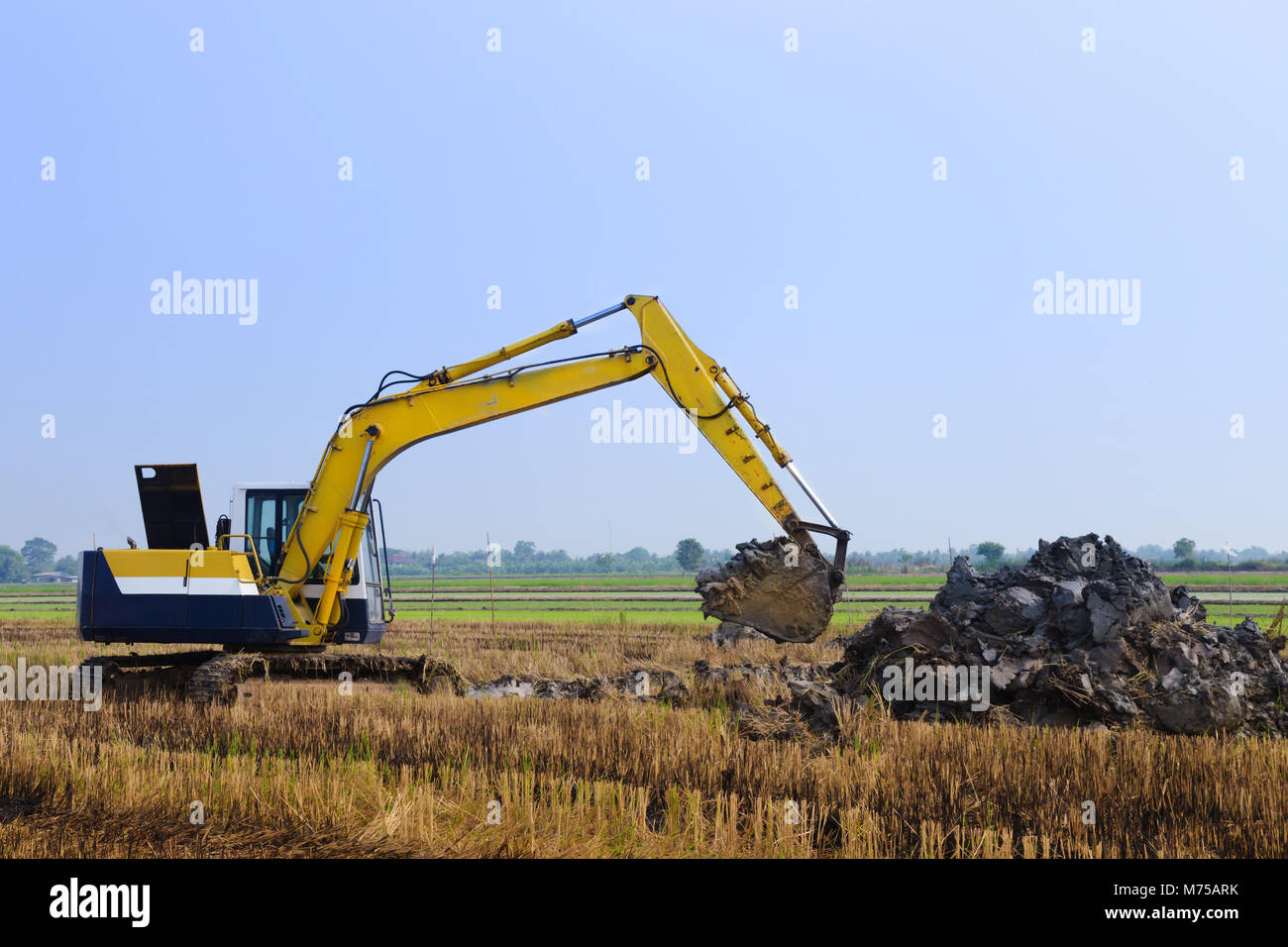 excavator backhoe working in the digging a soil to adjust the ...