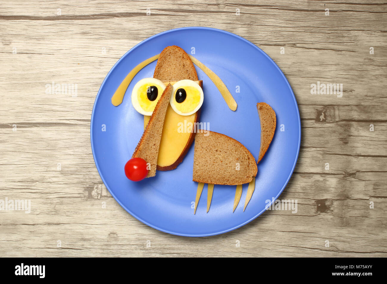 Funny sandwich dog made on wooden background Stock Photo - Alamy
