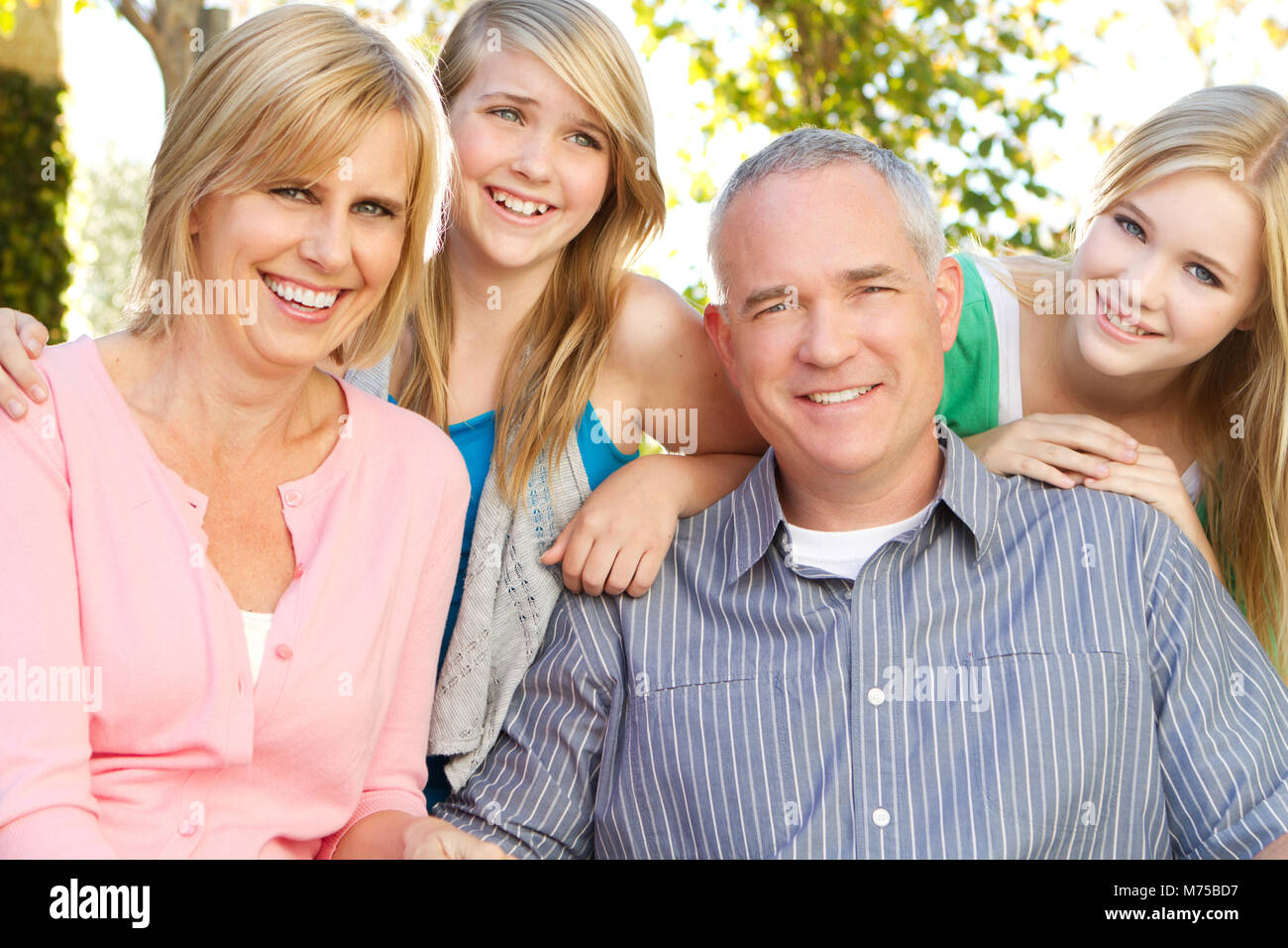Happy family smiling Stock Photo - Alamy