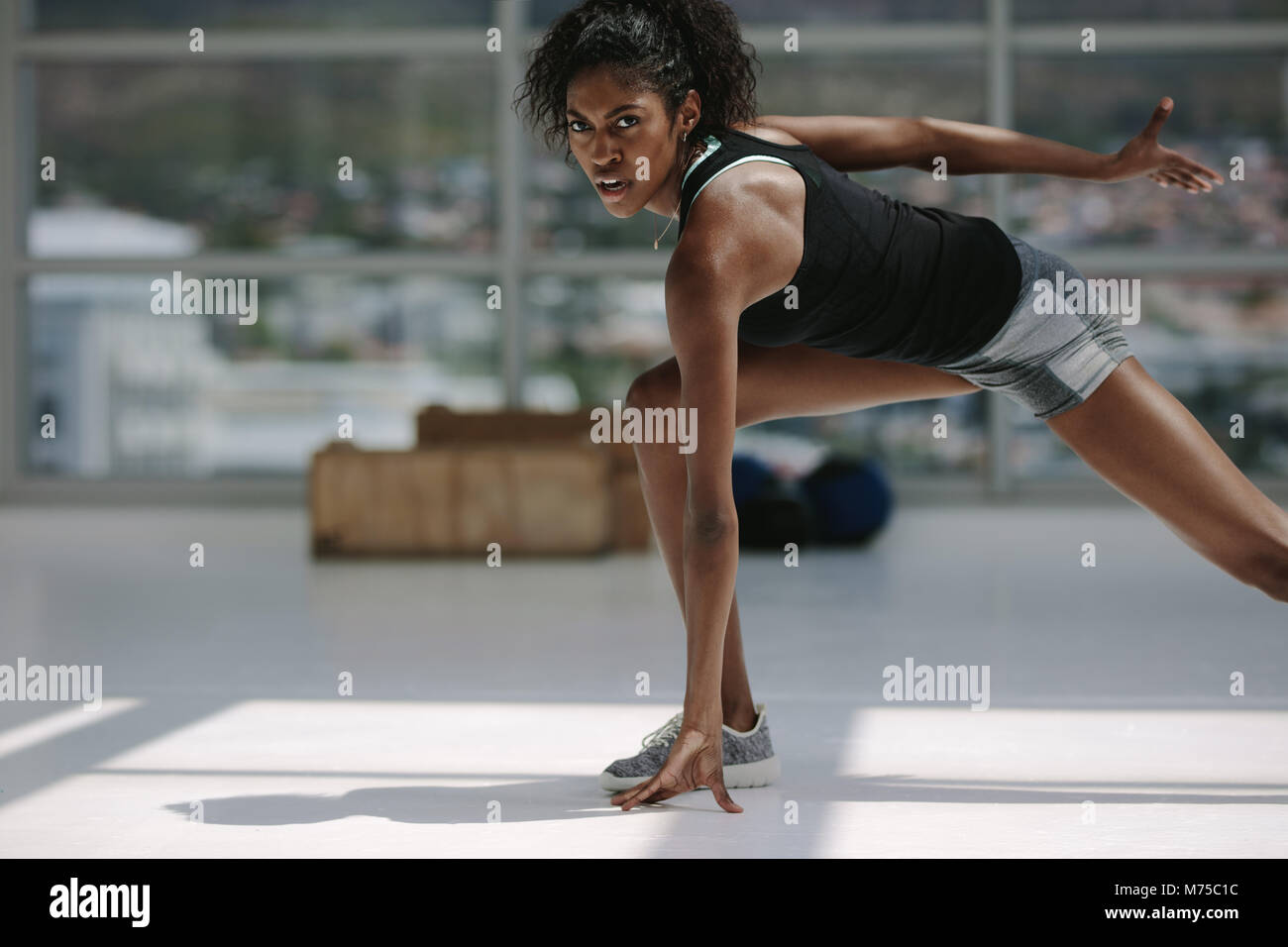 Healthy african woman working out in gym. Black sporty female ...