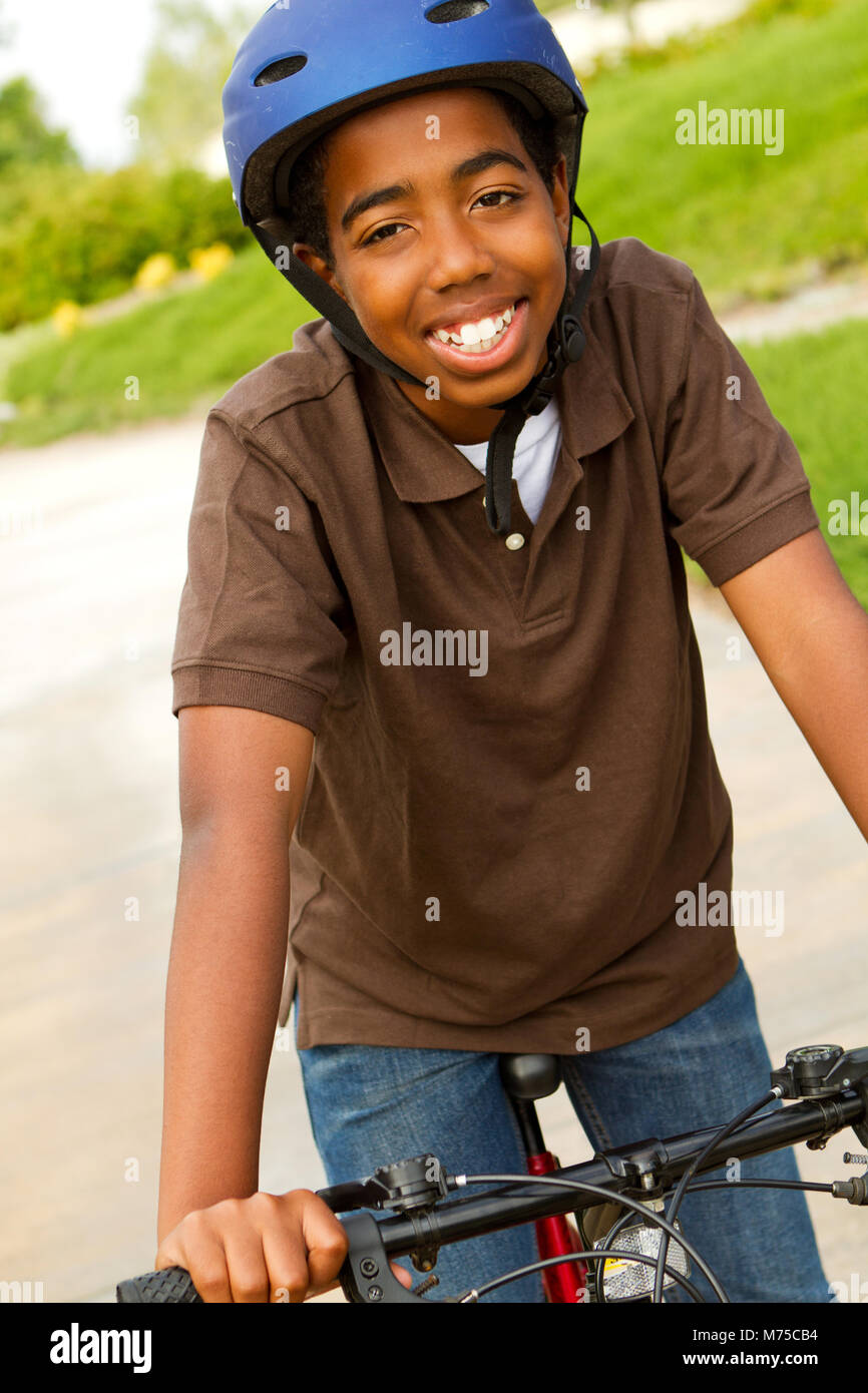 Happy young boy riding a bike Stock Photo - Alamy