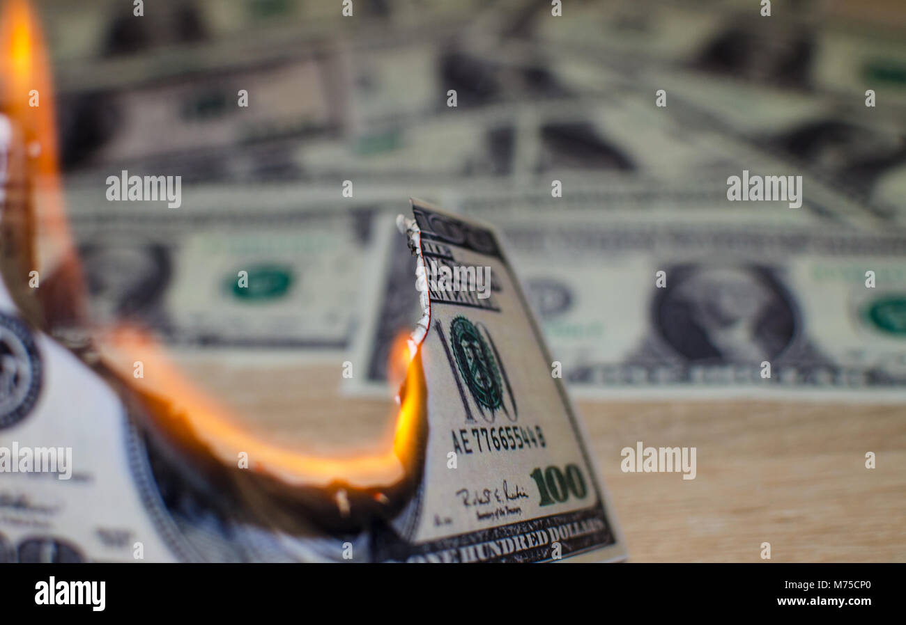 A dollar bill in American US currency is on fire Stock Photo - Alamy
