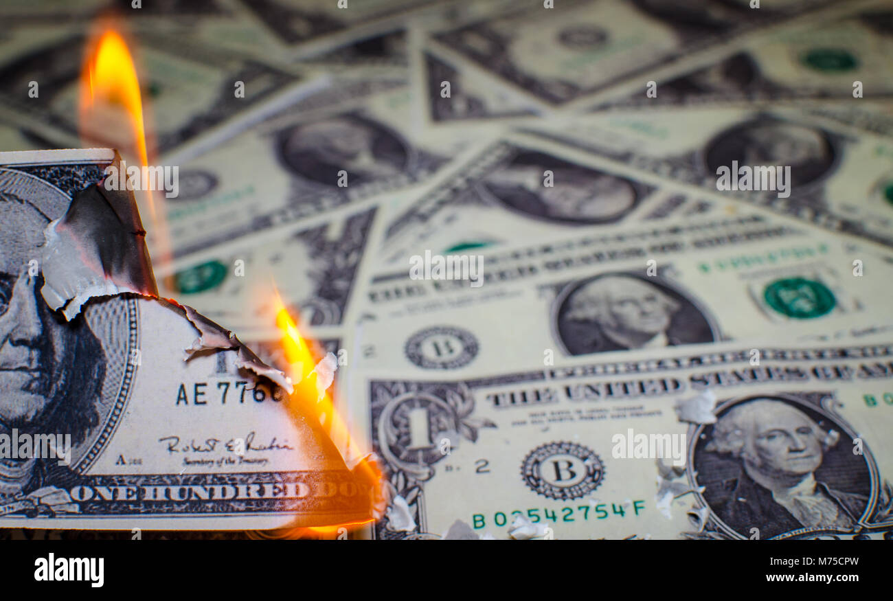 A dollar bill in American US currency is on fire Stock Photo - Alamy
