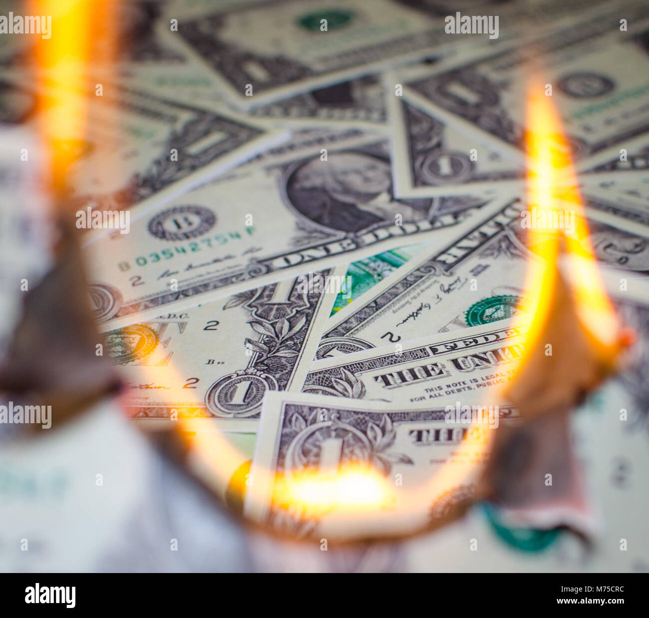 A dollar bill in American US currency is on fire Stock Photo - Alamy