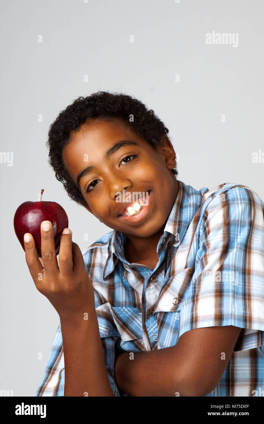 Young kid eating an apple Stock Photo - Alamy