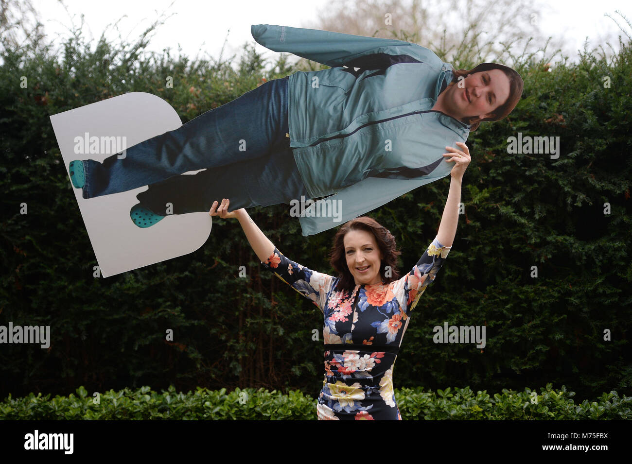 Laura Cosbie, 35, holds a cardboard cutout of herself before she lost ...