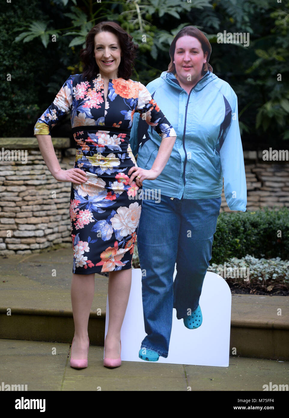 Laura Cosbie, 35, stands next to a cardboard cutout of herself before ...