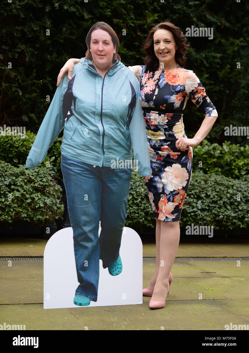 Laura Cosbie, 35, stands next to a cardboard cutout of herself before ...