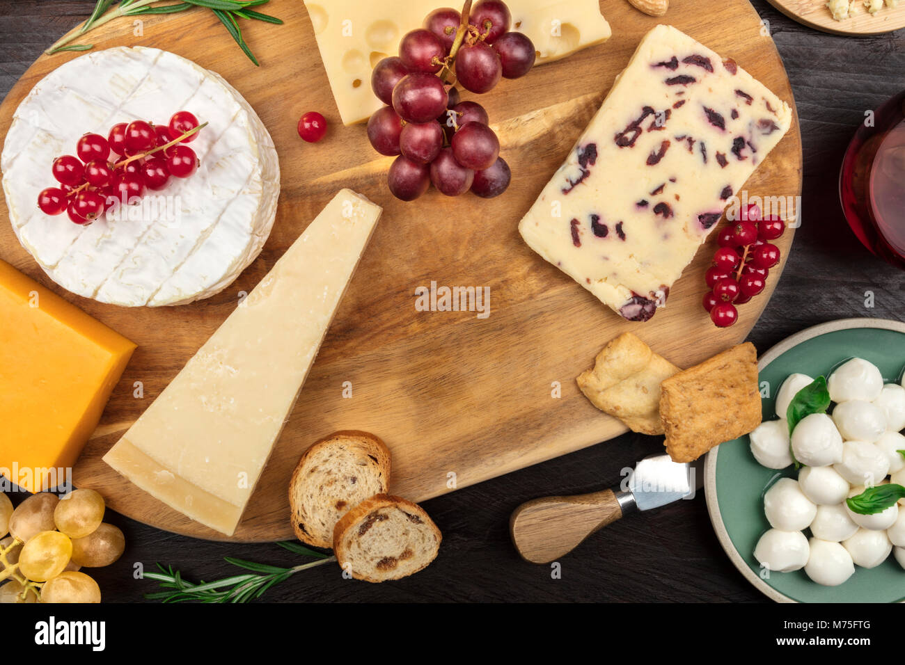 Various types of cheese on a dark rustic background with copy space ...