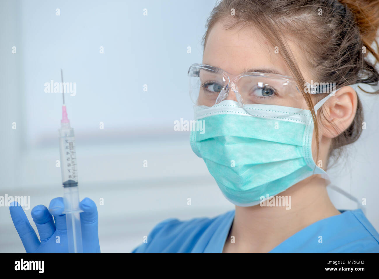 young nurse preparing injection with a syringe in hospital Stock Photo ...