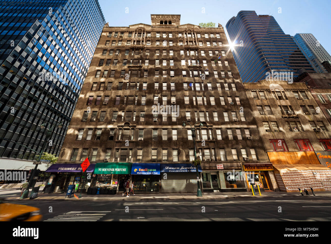 Old multi-storey building in Manhattan, New York City. Sun is coming ...