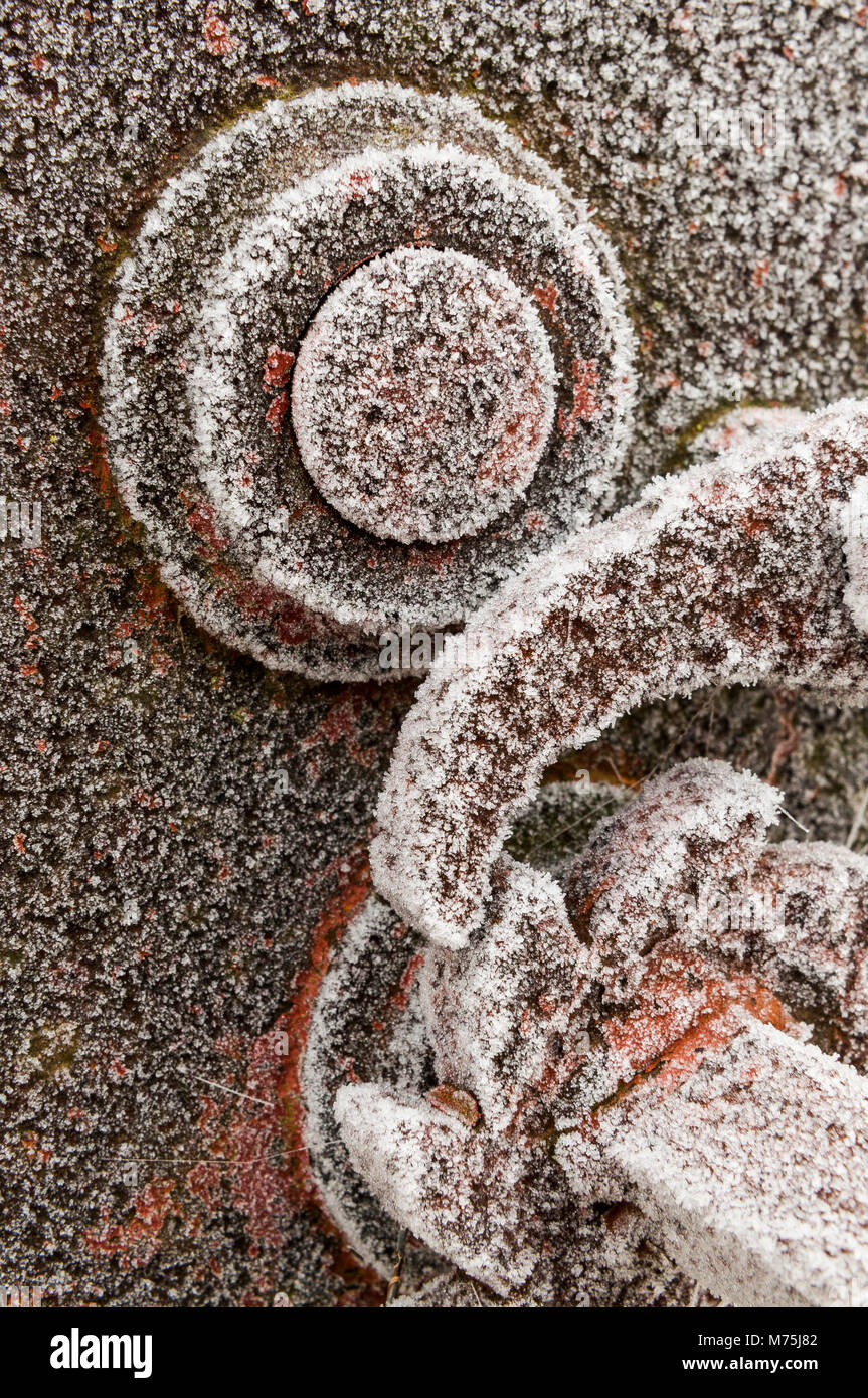 Ice art structures on frozen red colored iron structures along the road ...