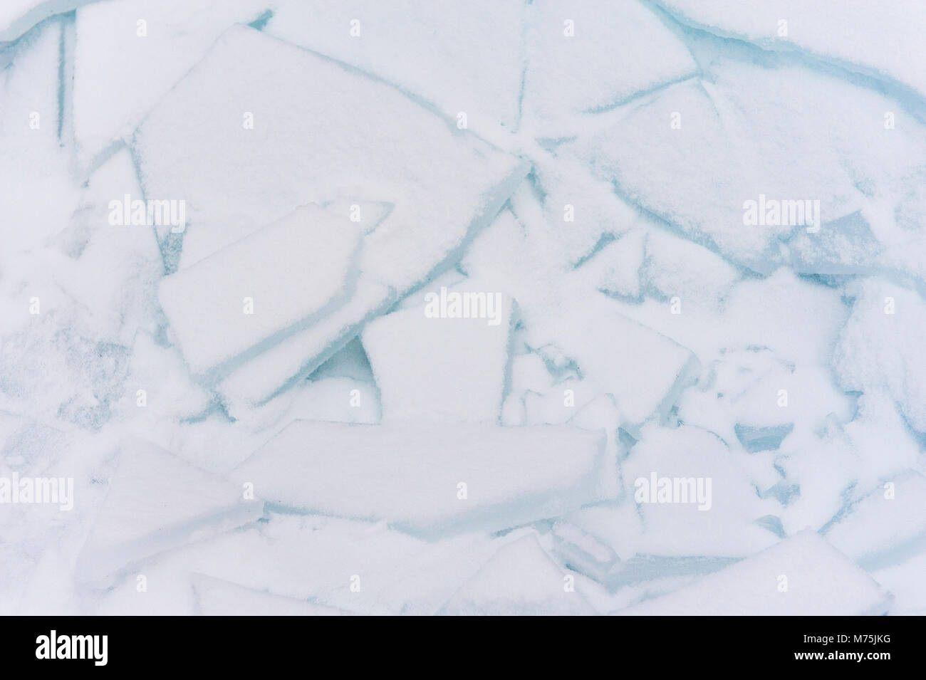 Snow falling on a beautiful texture of broken pieces of ice Stock Photo ...