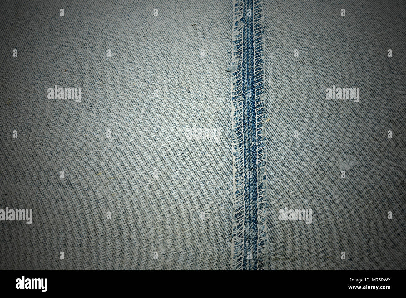 Old blue jean texture background and inside seam on the middle right ...