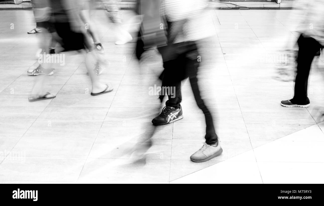 Motion blur people walking in fashion mall - black and white filter ...