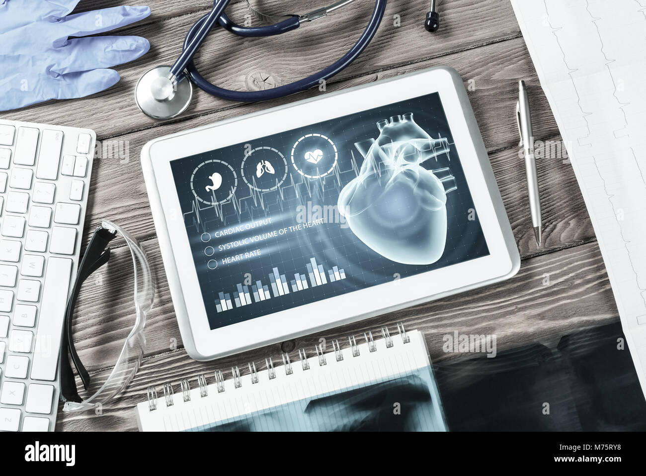 White tablet pc and doctor tools on wooden table Stock Photo - Alamy