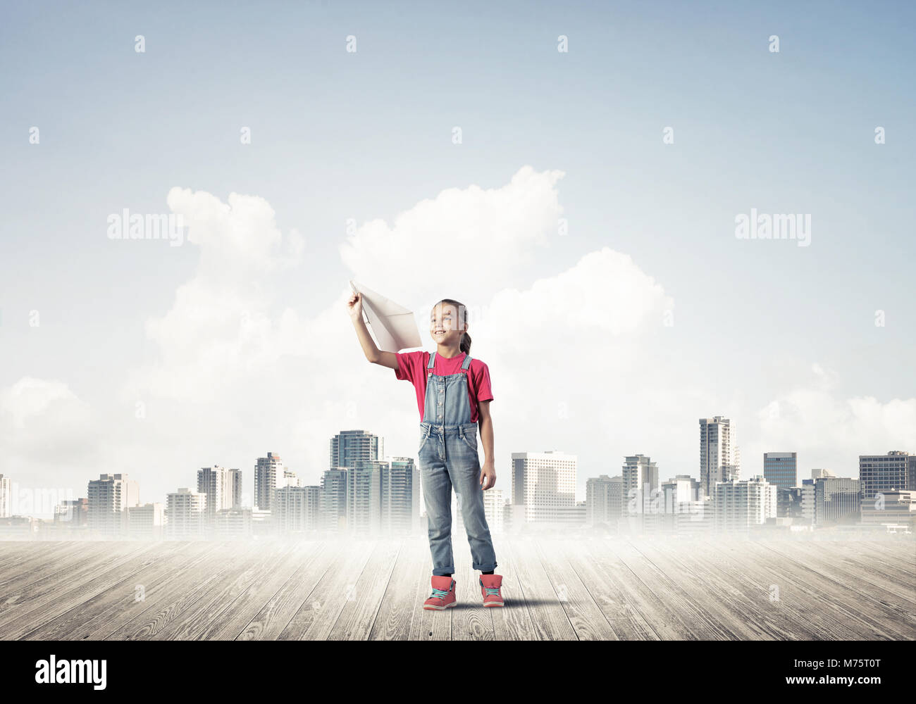 Cute kid girl standing on wooden floor with airplane Stock Photo - Alamy