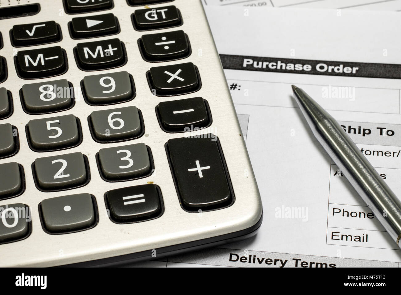 Purchasing order document, calculator and pen Stock Photo - Alamy