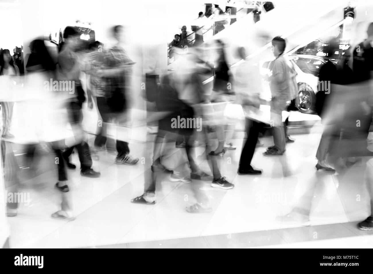 Motion blur people walking in fashion mall - black and white filter ...