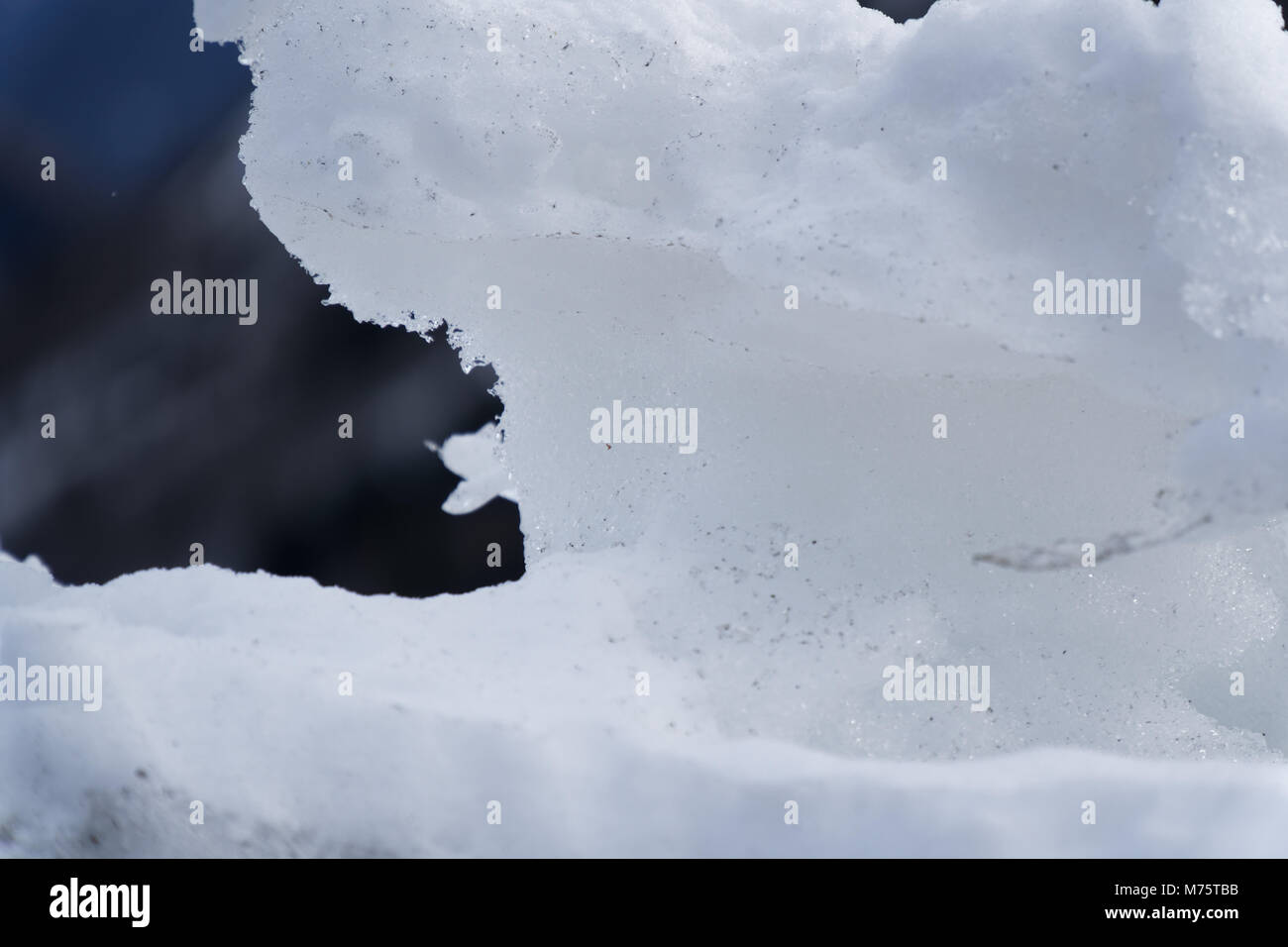 Snow Winter background, close-up of frosted ice lump on a snowing day ...