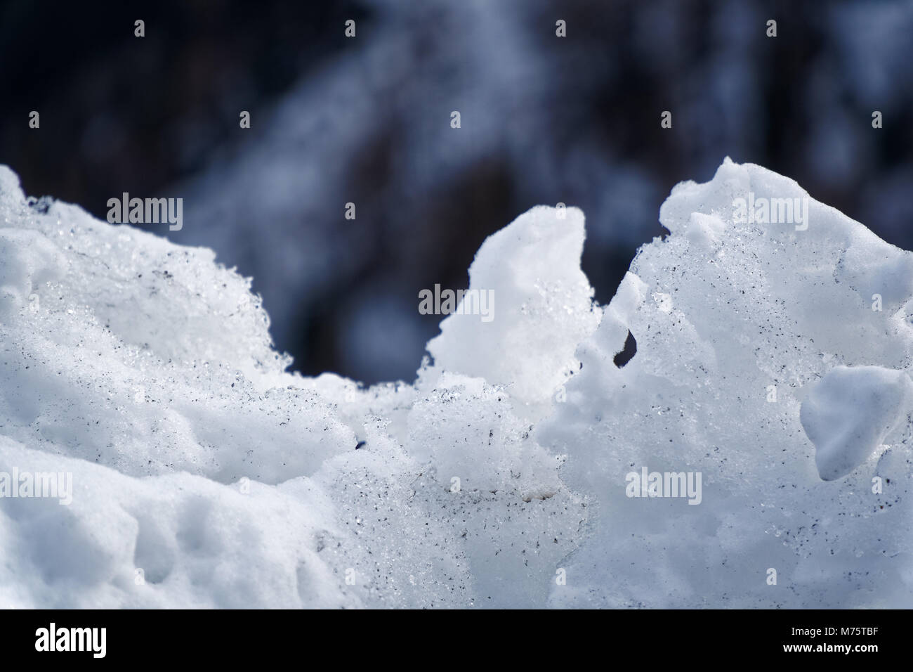 Snow Winter background, close-up of frosted ice lump on a snowing day ...