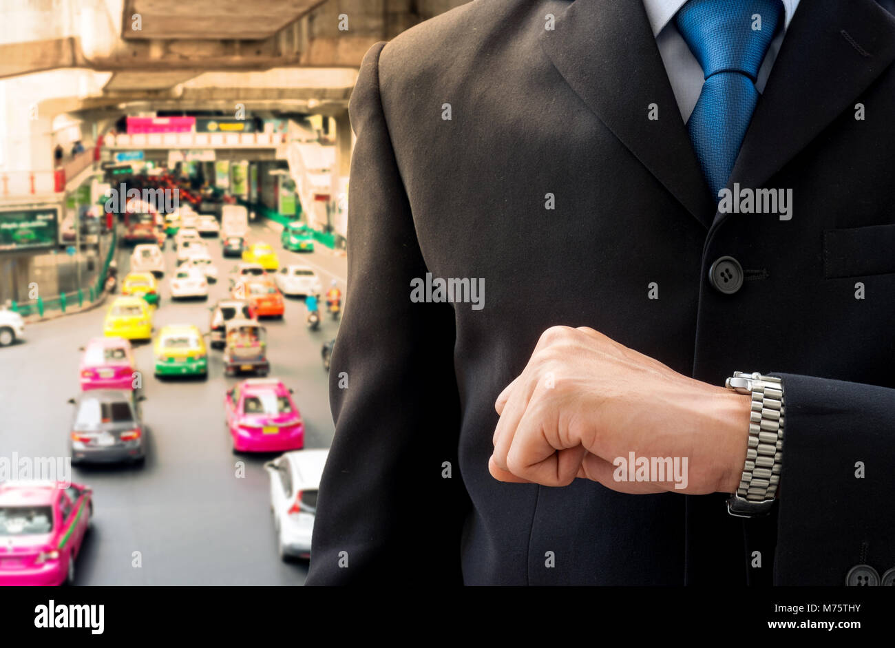 Businessman looking his watch to check time and bad traffic. Look like ...