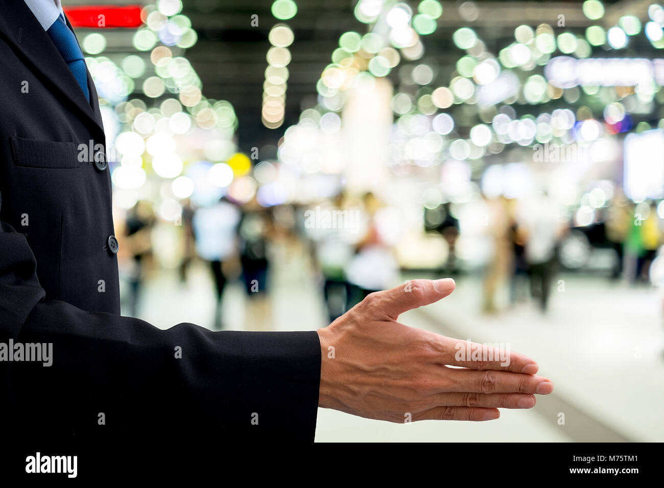 Isolated businessman in dark gray suit offer his right hand for ...