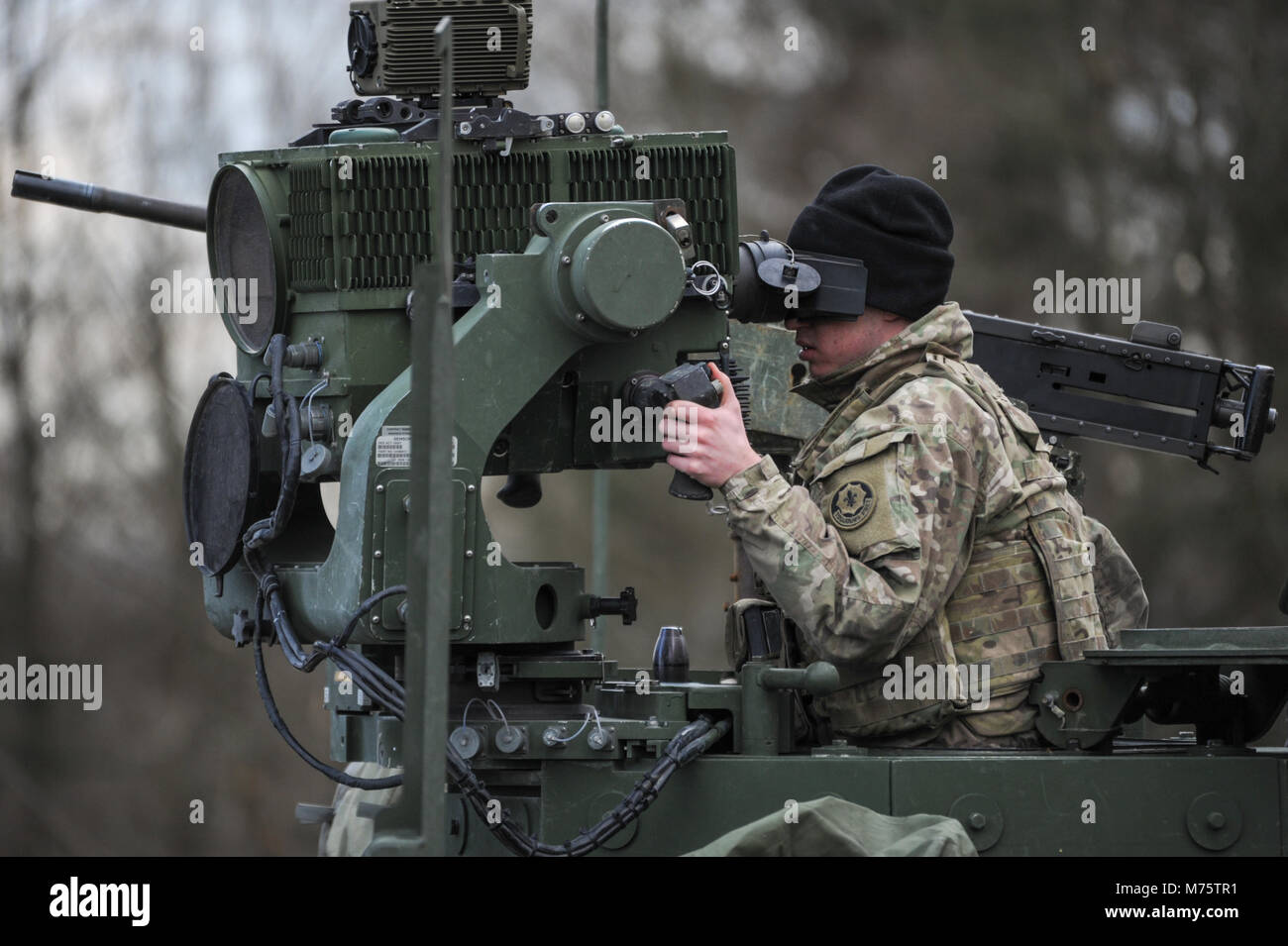 A U.S. Soldier with 2nd Cavalry Regiment observes the impact zone as ...