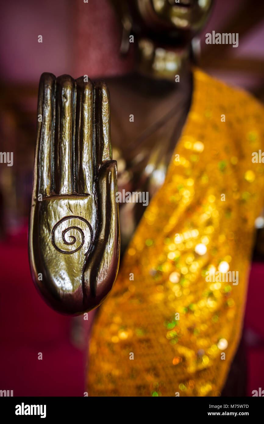 Golden buddha hand with spiral sign with shimmering yellow robe Stock ...