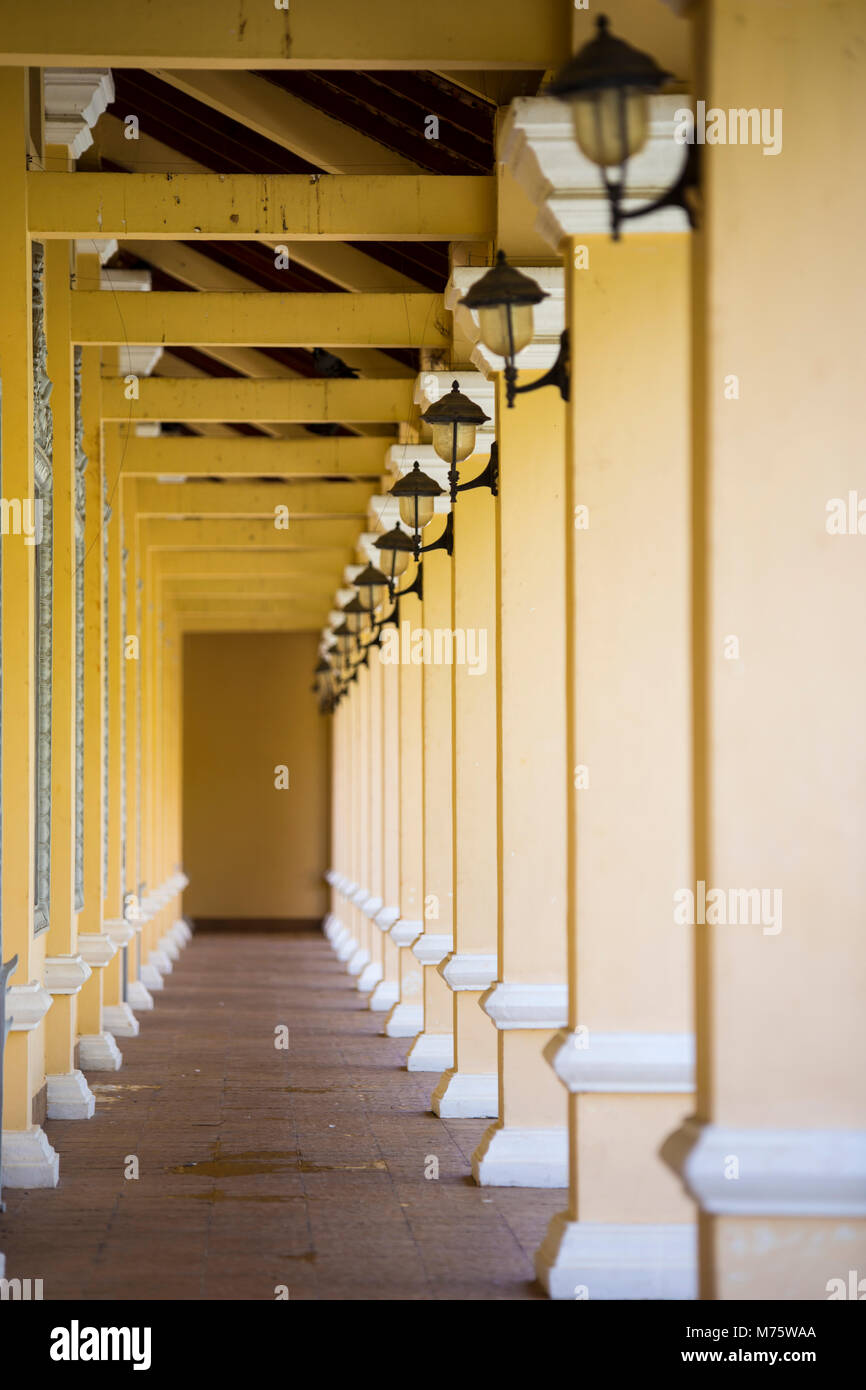 Colonial corridor architecture design with columns painted in yellow ...