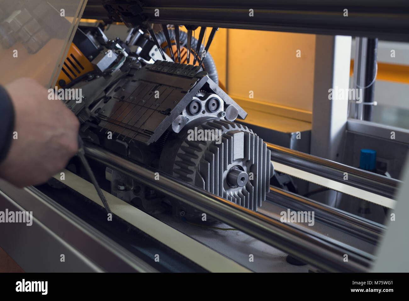 Serviceman setting up knitting machine hi-res stock photography and ...