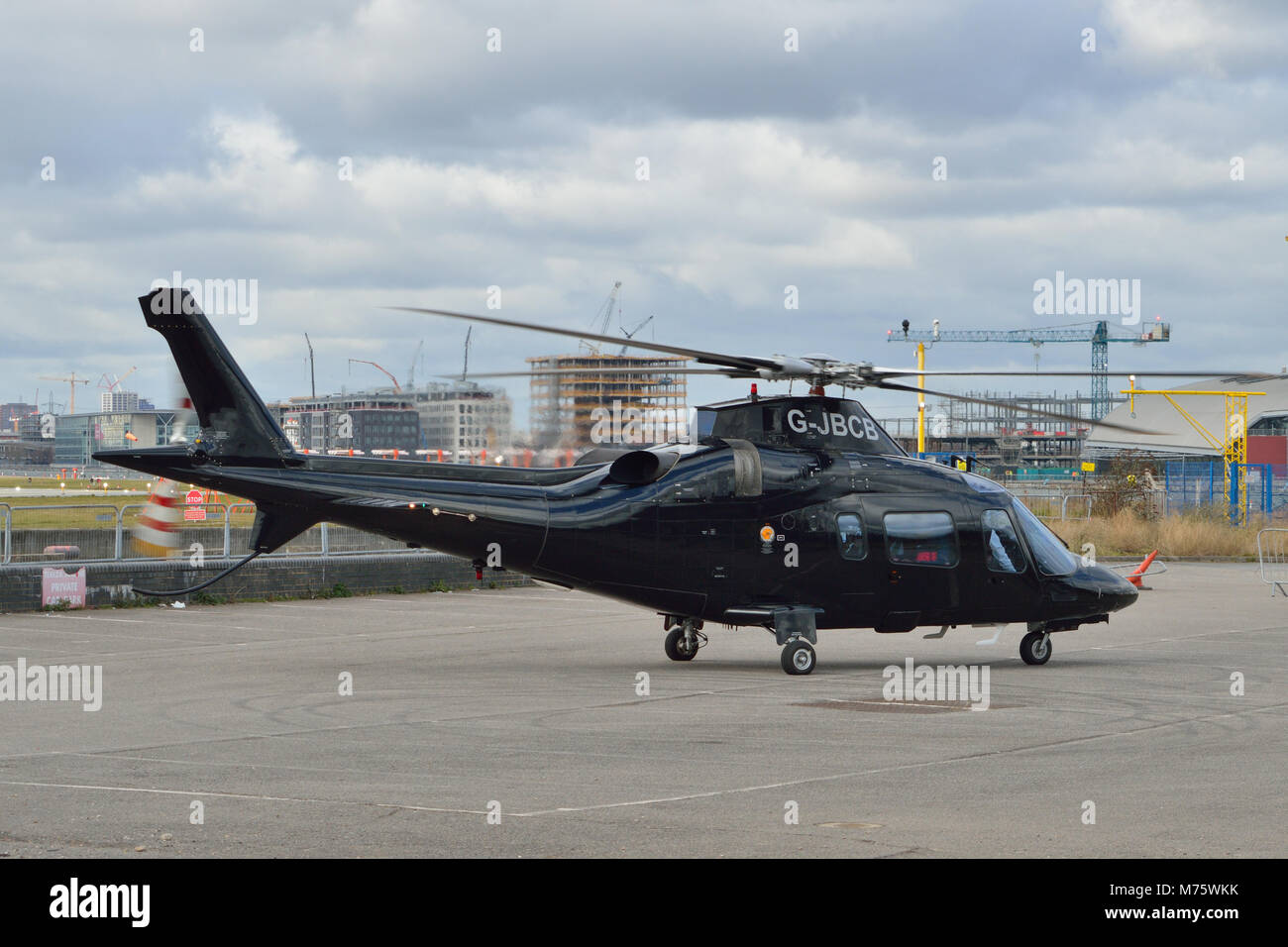 Castle Air Augusta A109 helicopter on the ground in a car park adjacent ...