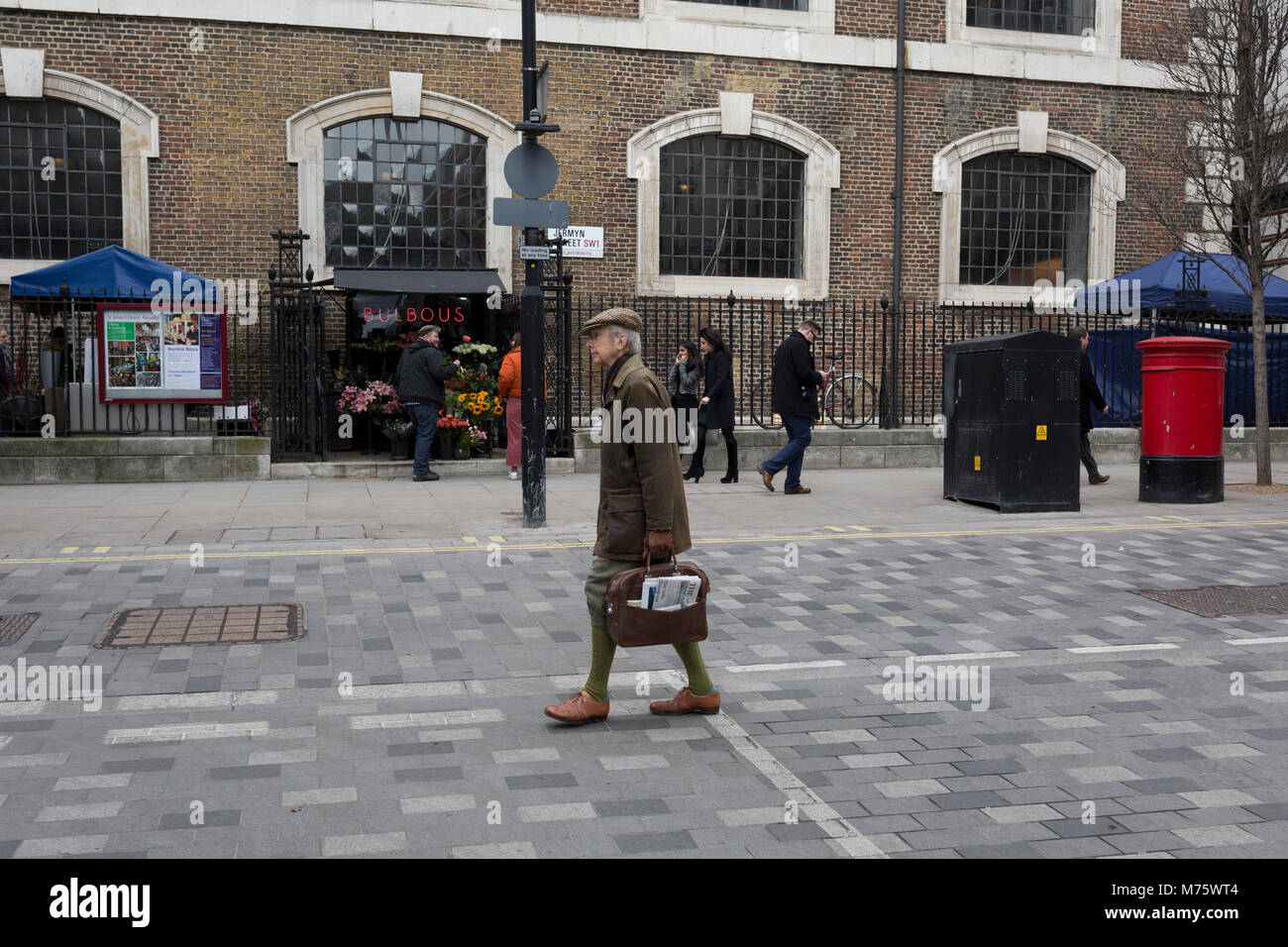 An elderly gentleman wearing Plus fours, a wax jacket, tweed flat cap ...