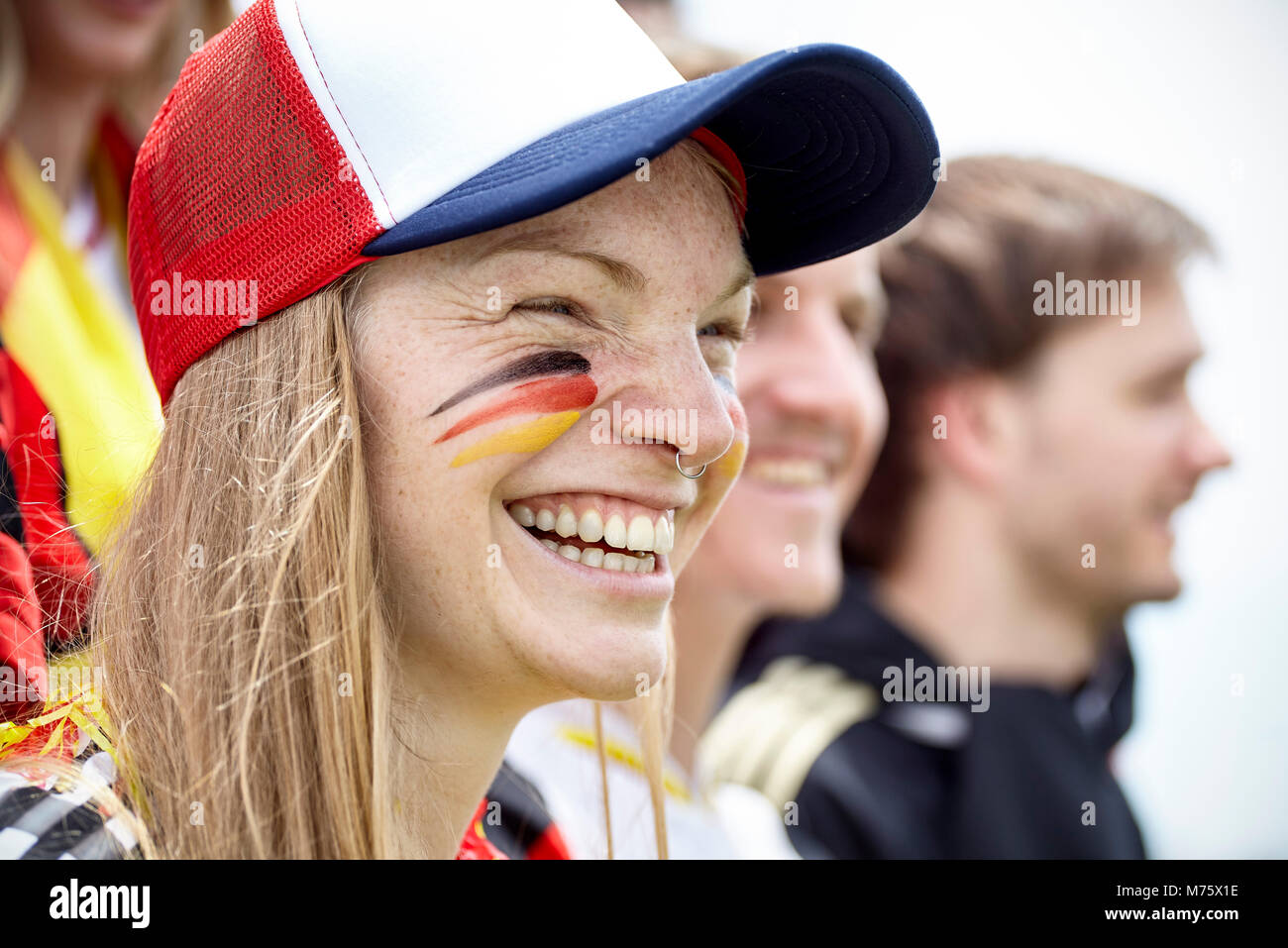 German football fan smiling at match Stock Photo - Alamy